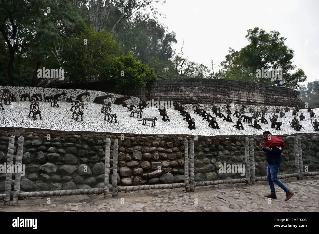 A visitor explores the rock garden (a sculpture garden) on a cloudy day ...
