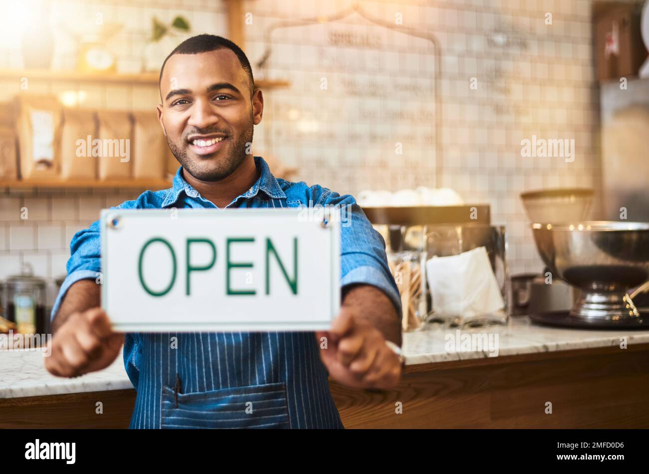 Open and ready to offer you the best service. Portrait of a young man ...