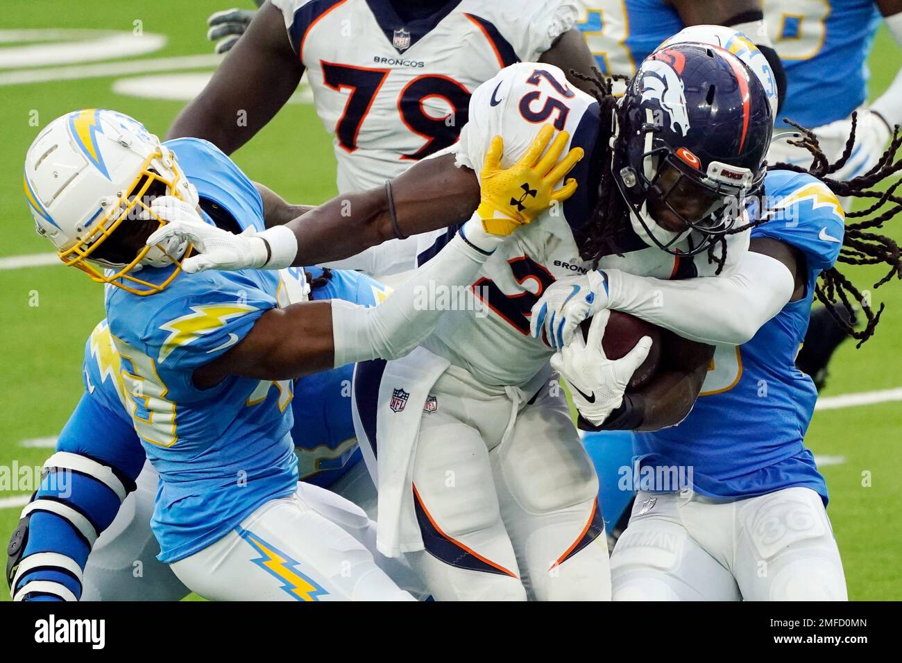 Denver Broncos running back Melvin Gordon (25) is tackled by Los ...