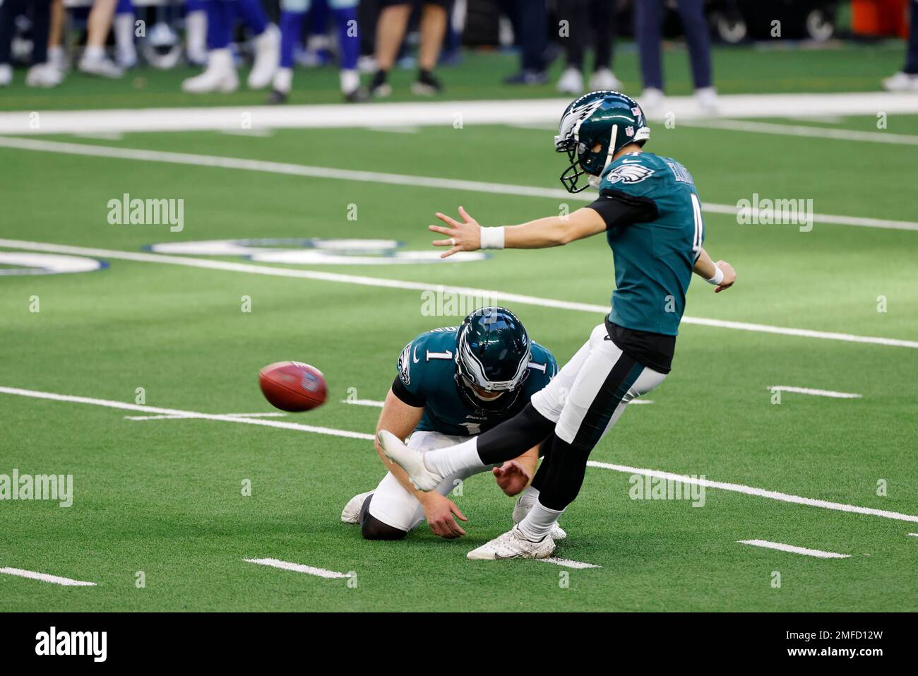Philadelphia Eagles place kicker Jake Elliott, right, kicks an extra ...