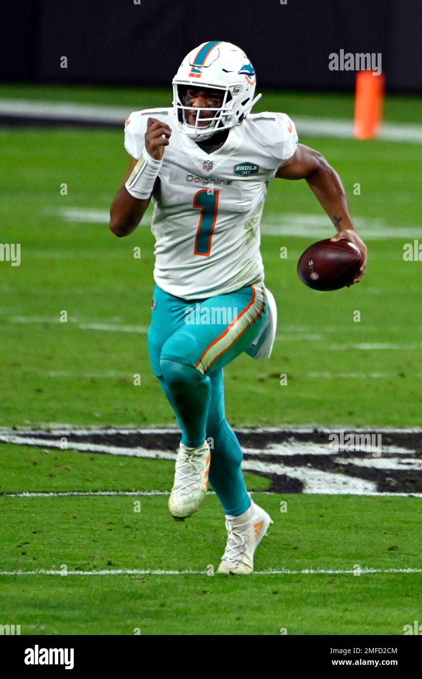 Miami Dolphins quarterback Tua Tagovailoa (1) runs with the ball ...