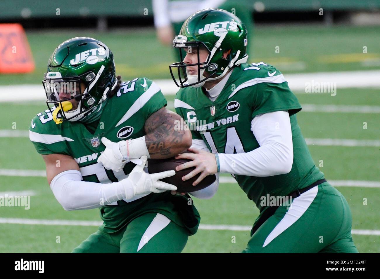 New York Jets quarterback Sam Darnold, right, fakes the hand off to Ty Johnson during the first ...