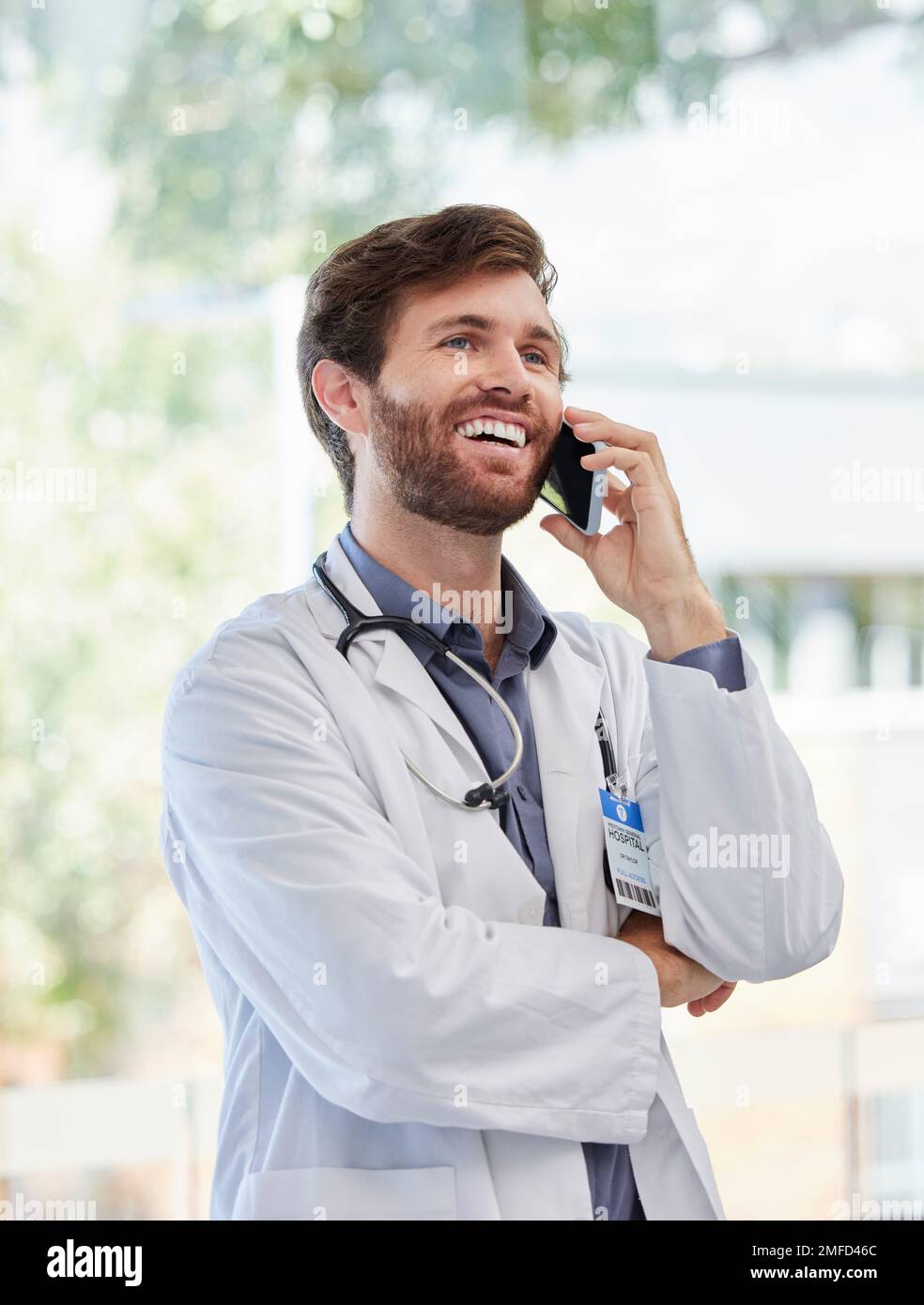 Doctor, man and phone call with smile at hospital for conversation ...