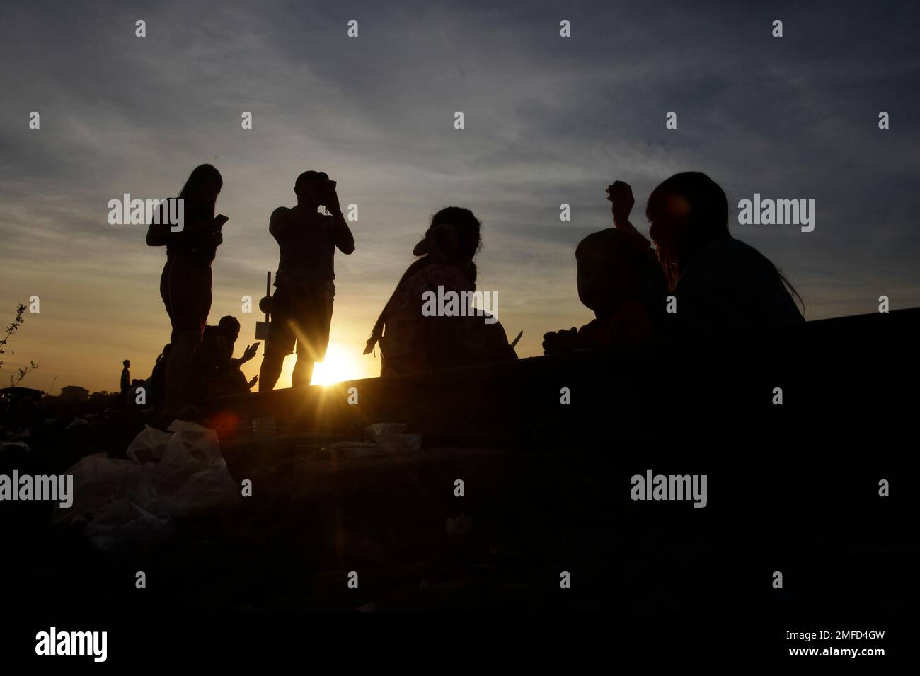 Cambodian garment workers relax weekend as they sit on rail tracks on ...