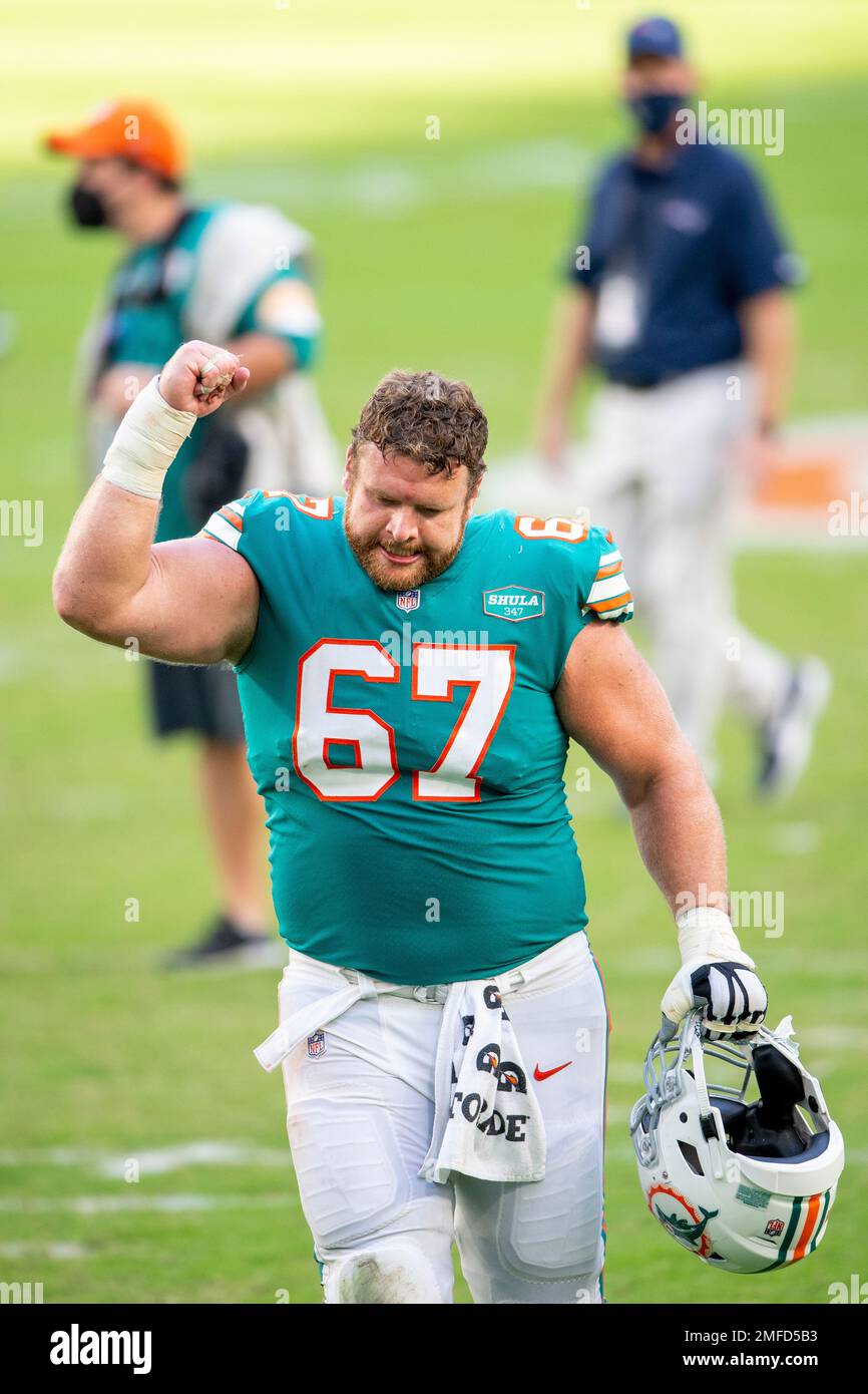 Miami Dolphins guard Ted Karras (67) raises his fist on the field as he ...