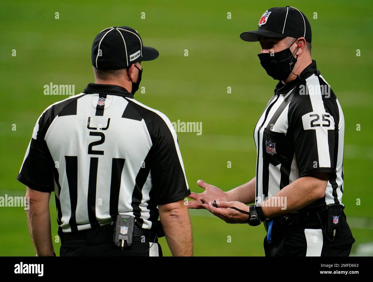 Line judge Bart Longson #2 and side judge Bob Waggoner #25 talk during ...