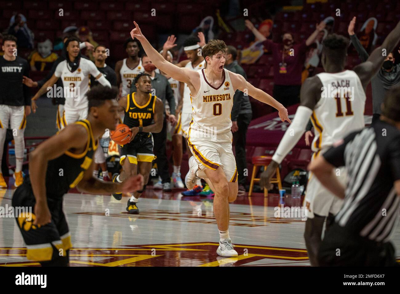 Minnesota center Liam Robbins (0) celebrates a basket against Iowa in ...