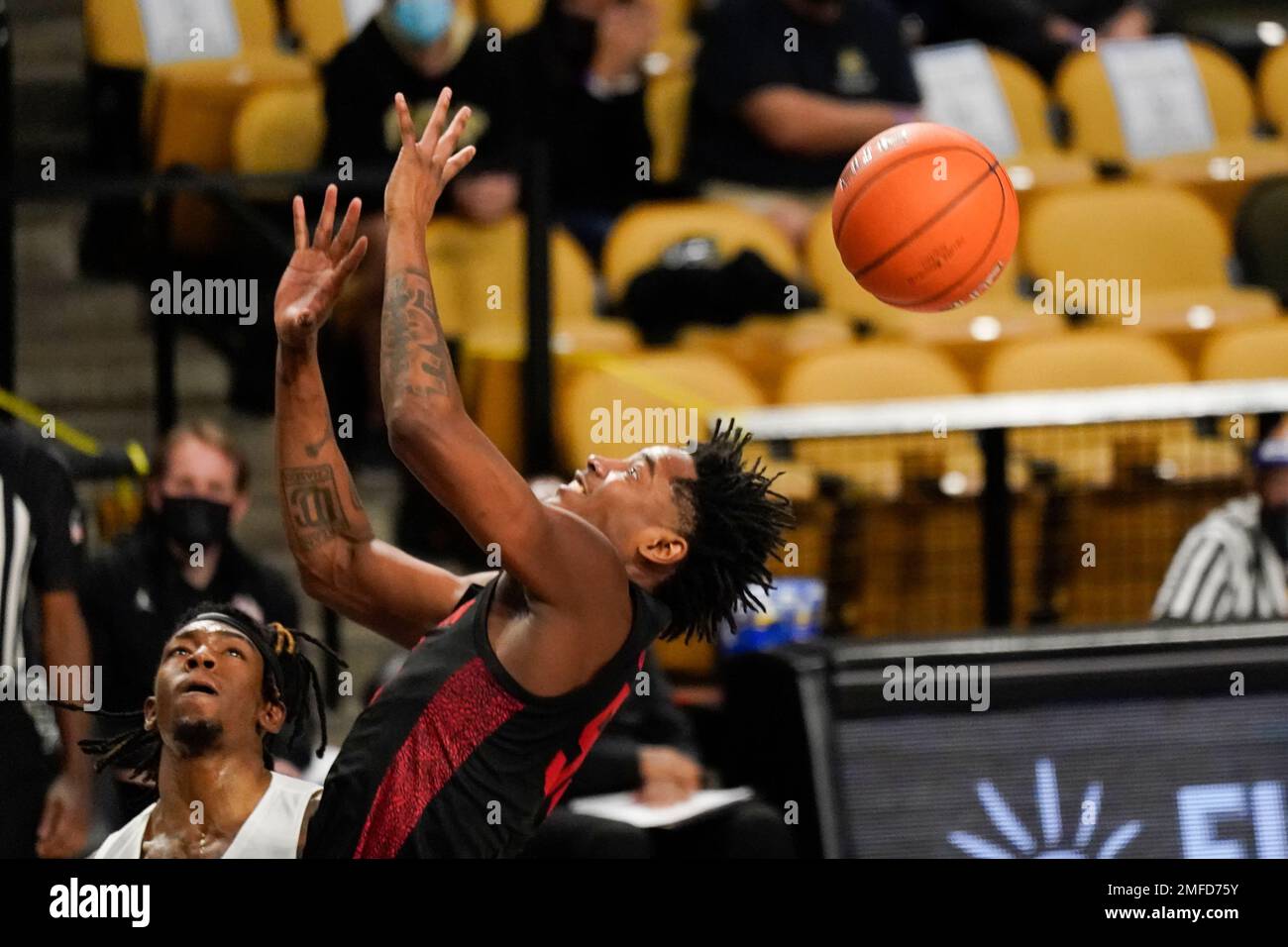 Houston forward Brison Gresham, right, tries but can't get a rebound in front of Central Florida ...