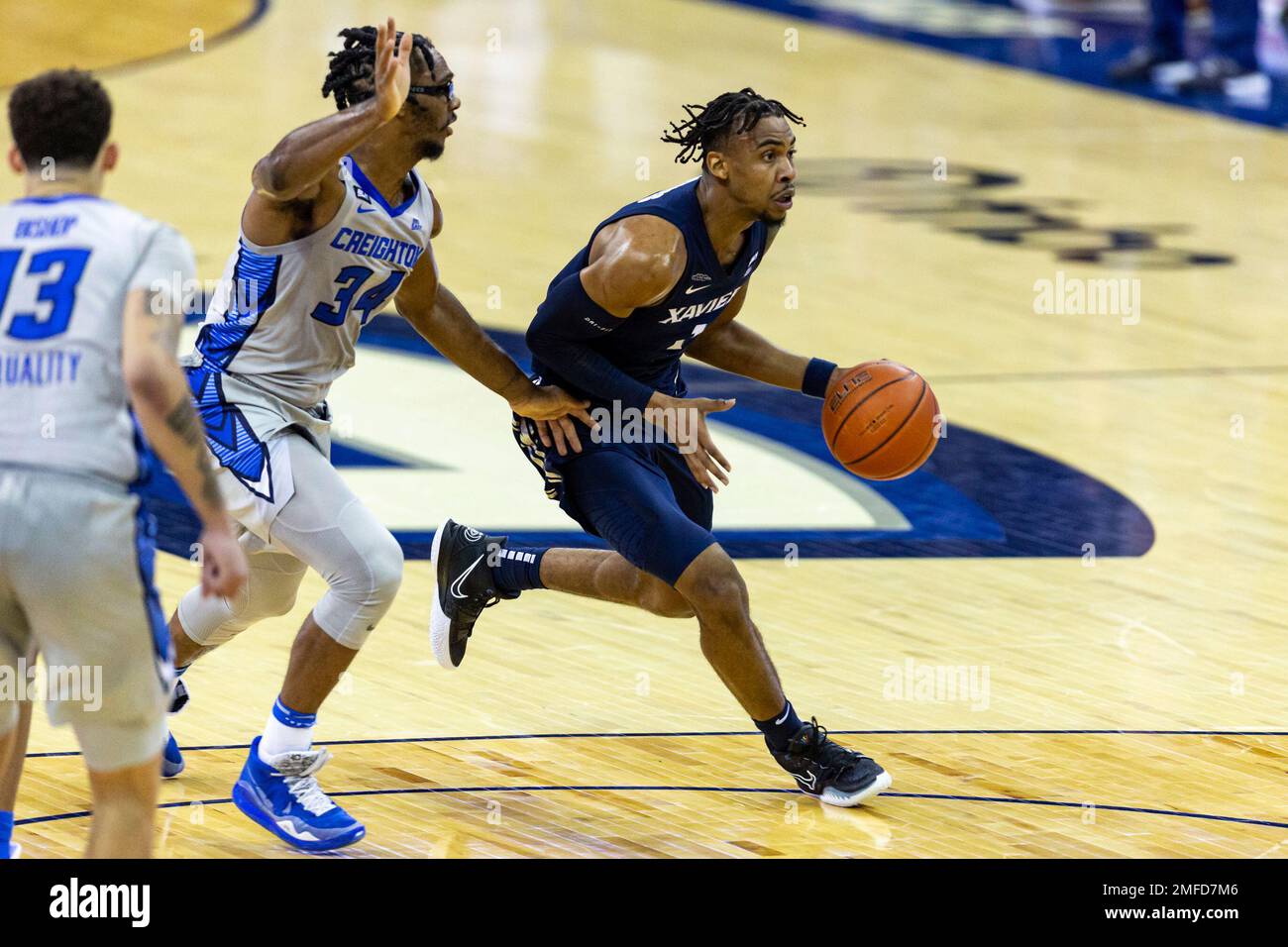 Xavier forward Ben Stanley (14) dribbles around Creighton guard Denzel ...