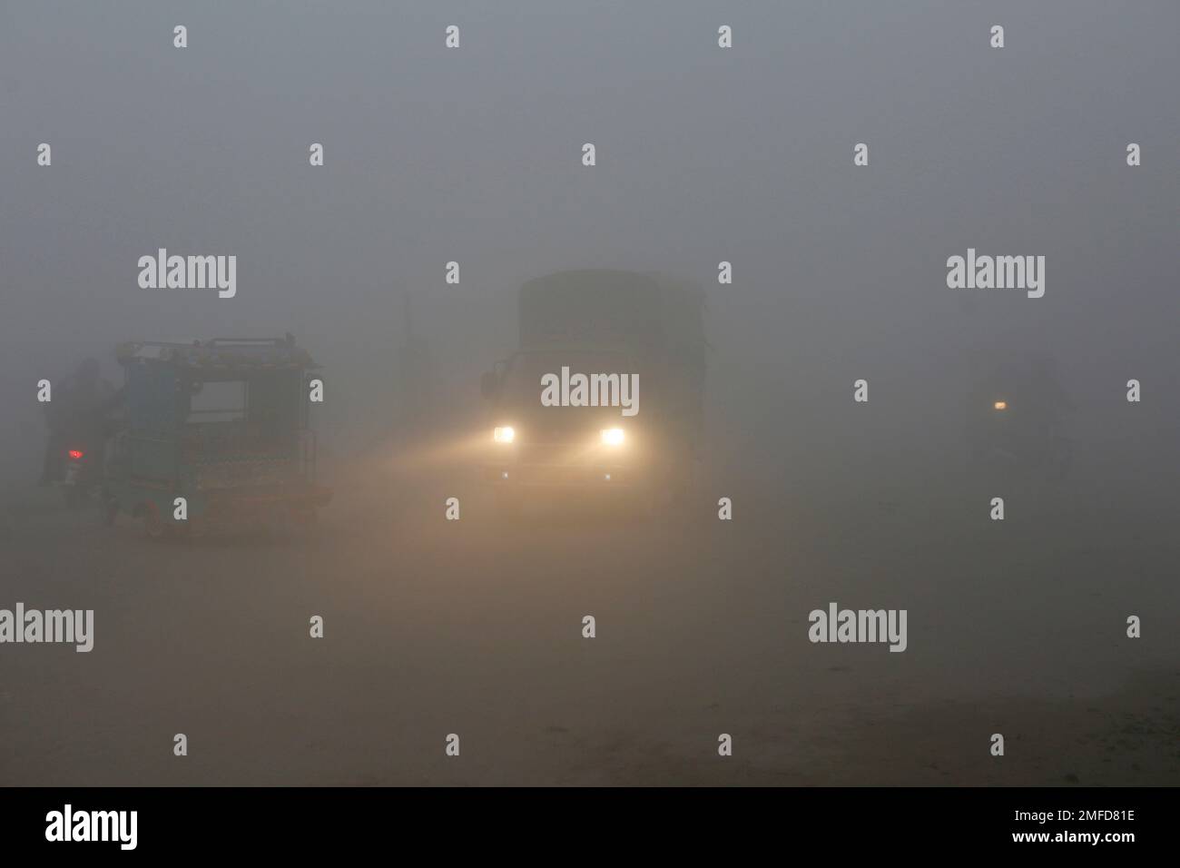 A van is driven with headlights while heavy fog envelope the areas of ...