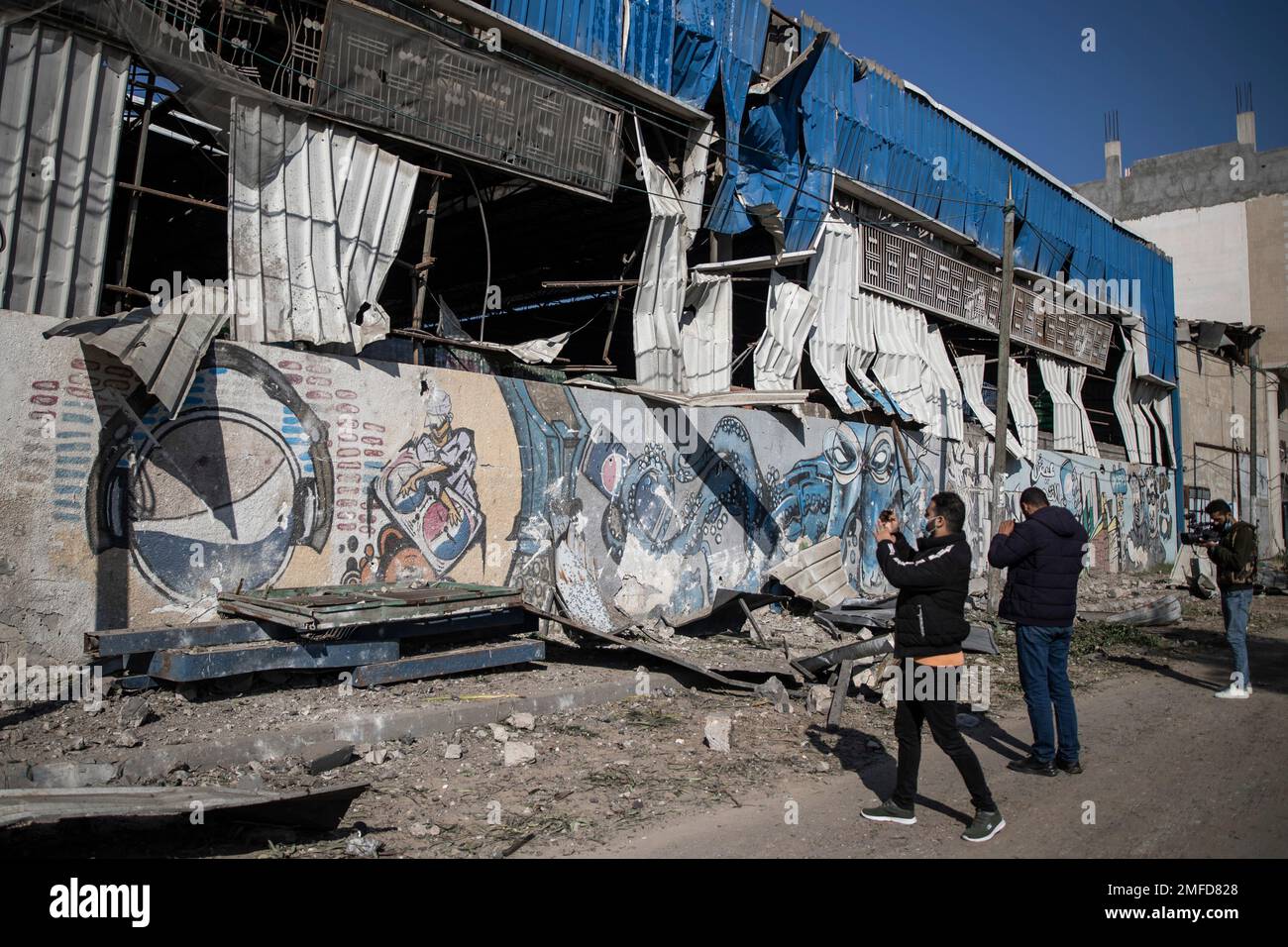 Palestinian journalists photograph a partially destroyed soft drink ...