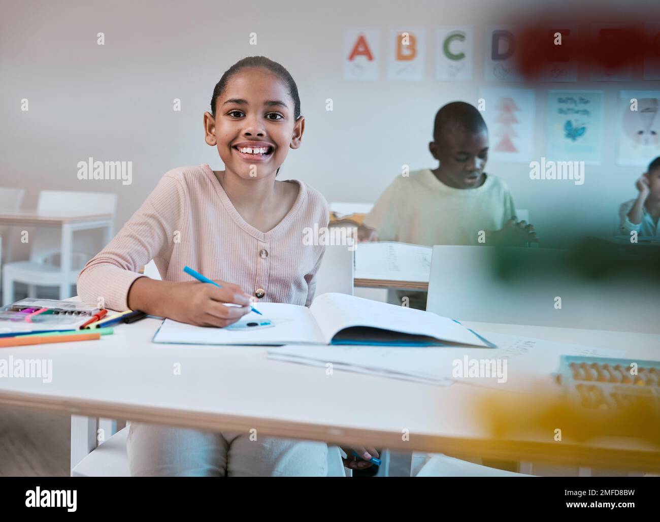 Education, class and portrait of child with smile in classroom learning ...