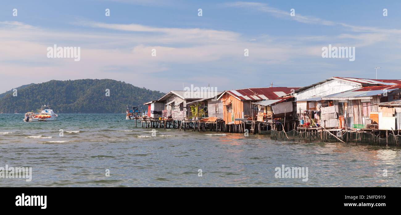 Colorful coastal wooden houses and barns on stilts in poor district of ...