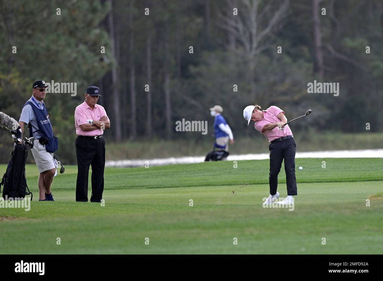 Lee Trevino, center, watches as his son Daniel hits from the 14th ...