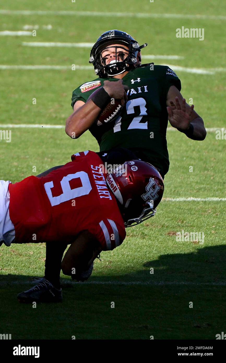 Hawaii quarterback Chevan Cordeiro (12) is tackled by Houston ...