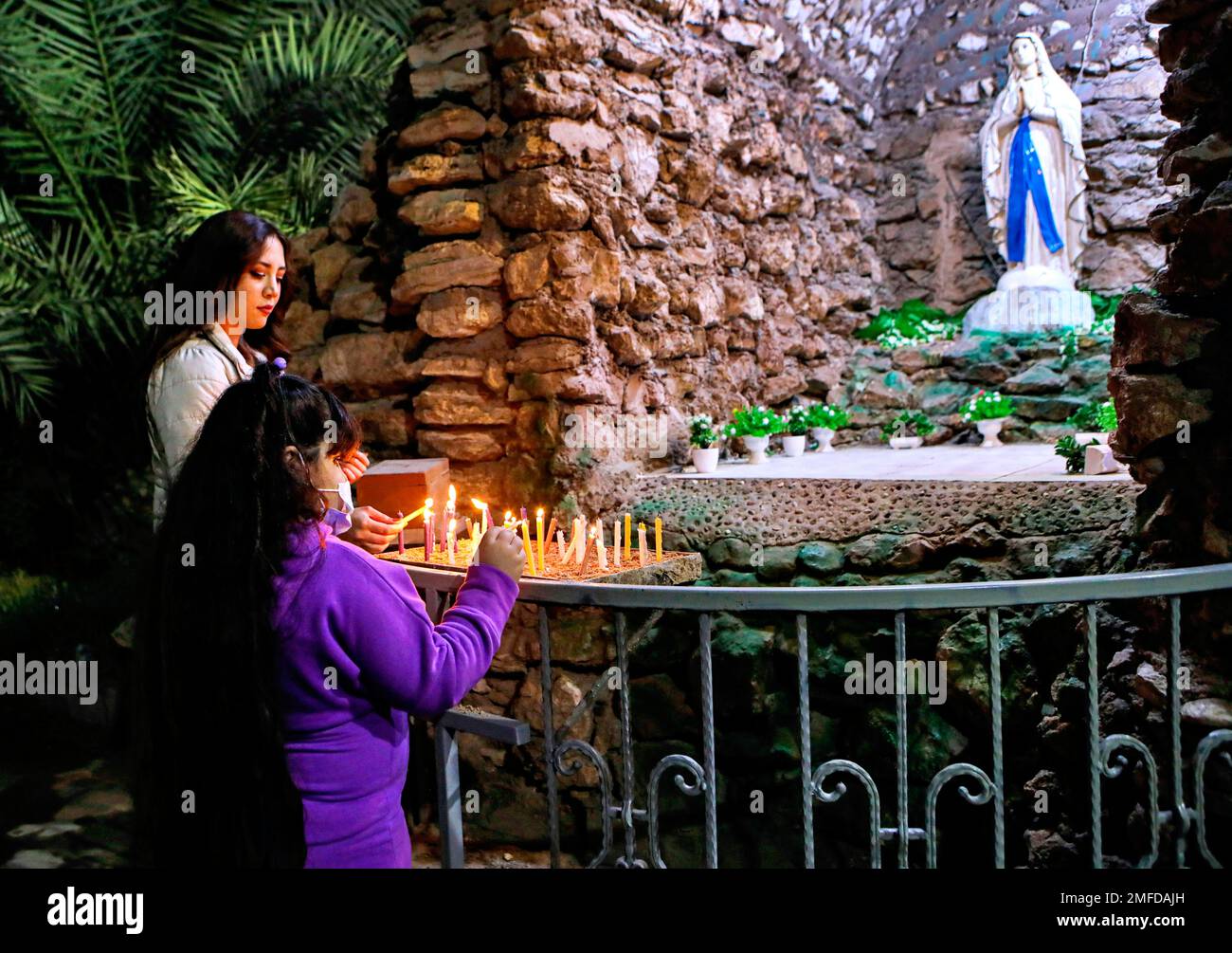 Iraqi Christians light candles during Christmas Eve Mass in the holy ...