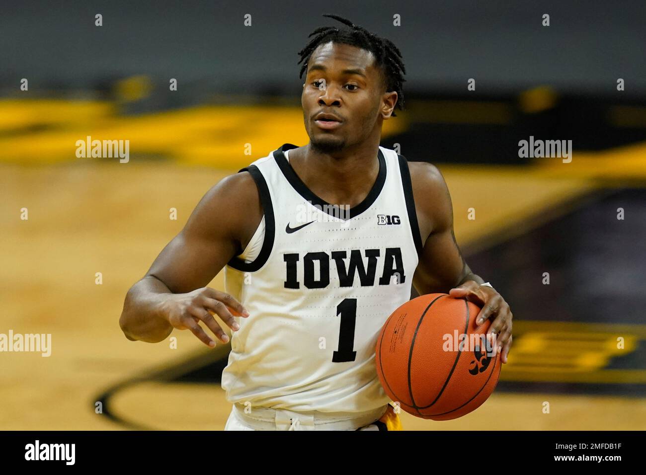 Iowa guard Joe Toussaint dribbles up court during an NCAA college ...