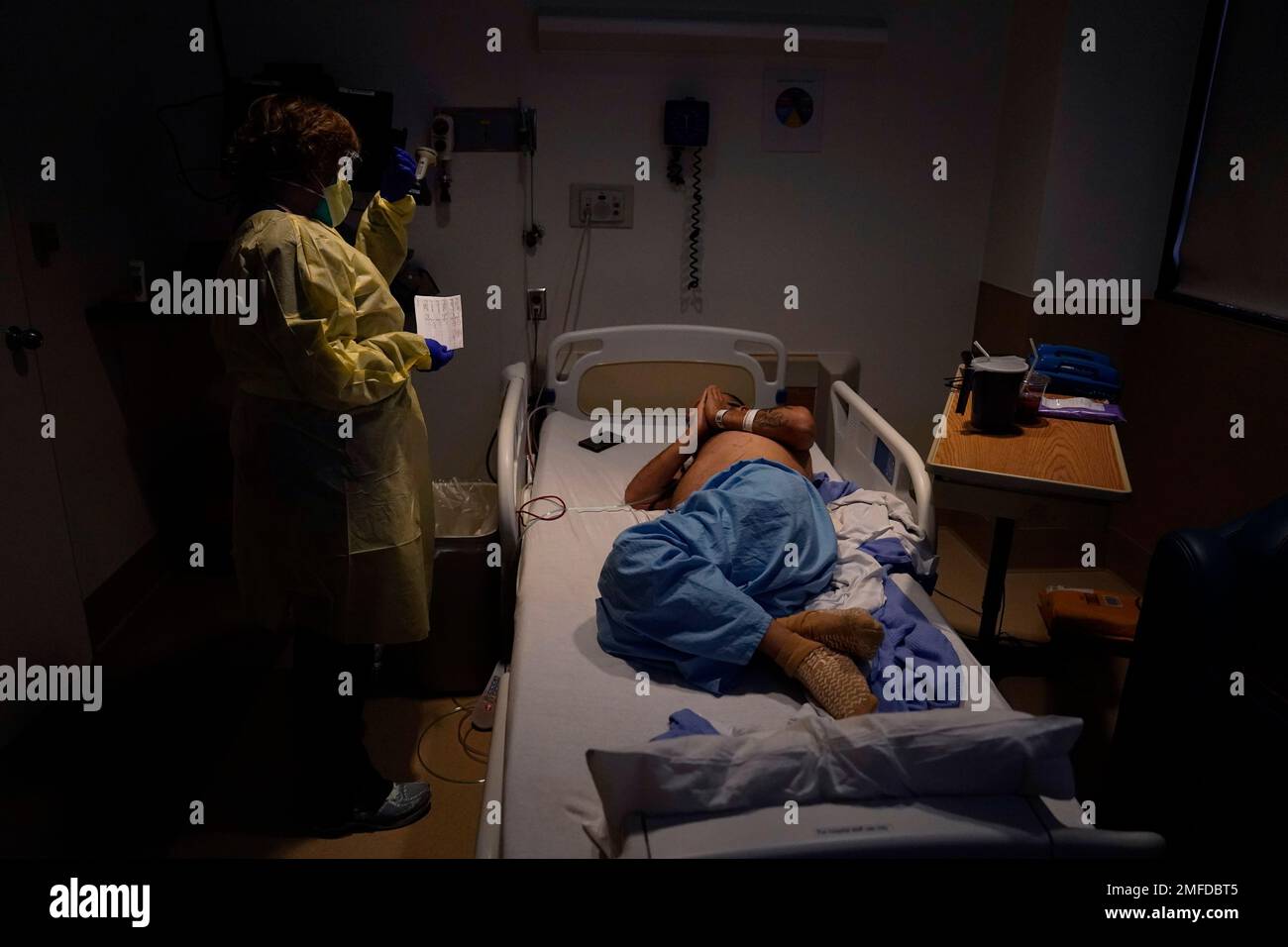 Senior chaplain Nancy Many, left, prays with Rafael Lopez in a COVID-19 ...