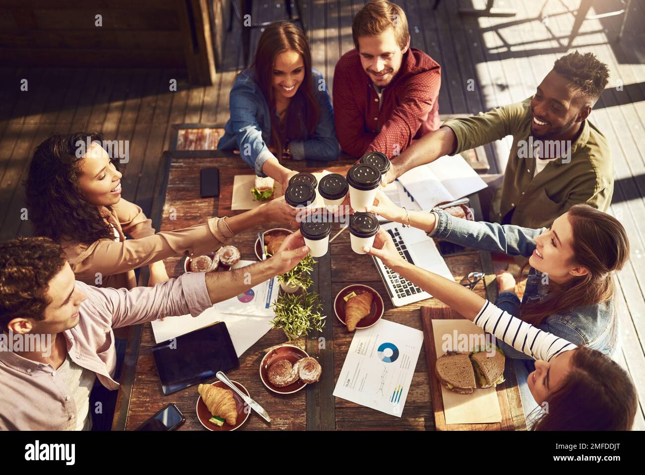 Heres to success. High angle shot of a group of creative workers ...