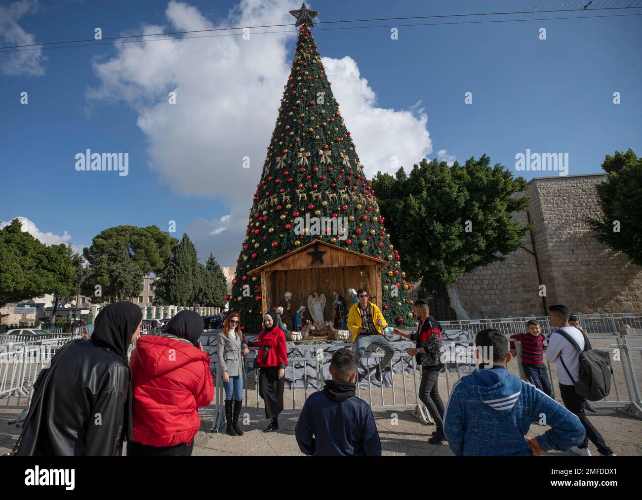 Palestinians take pictures with the Nativity scene and the Christmas ...