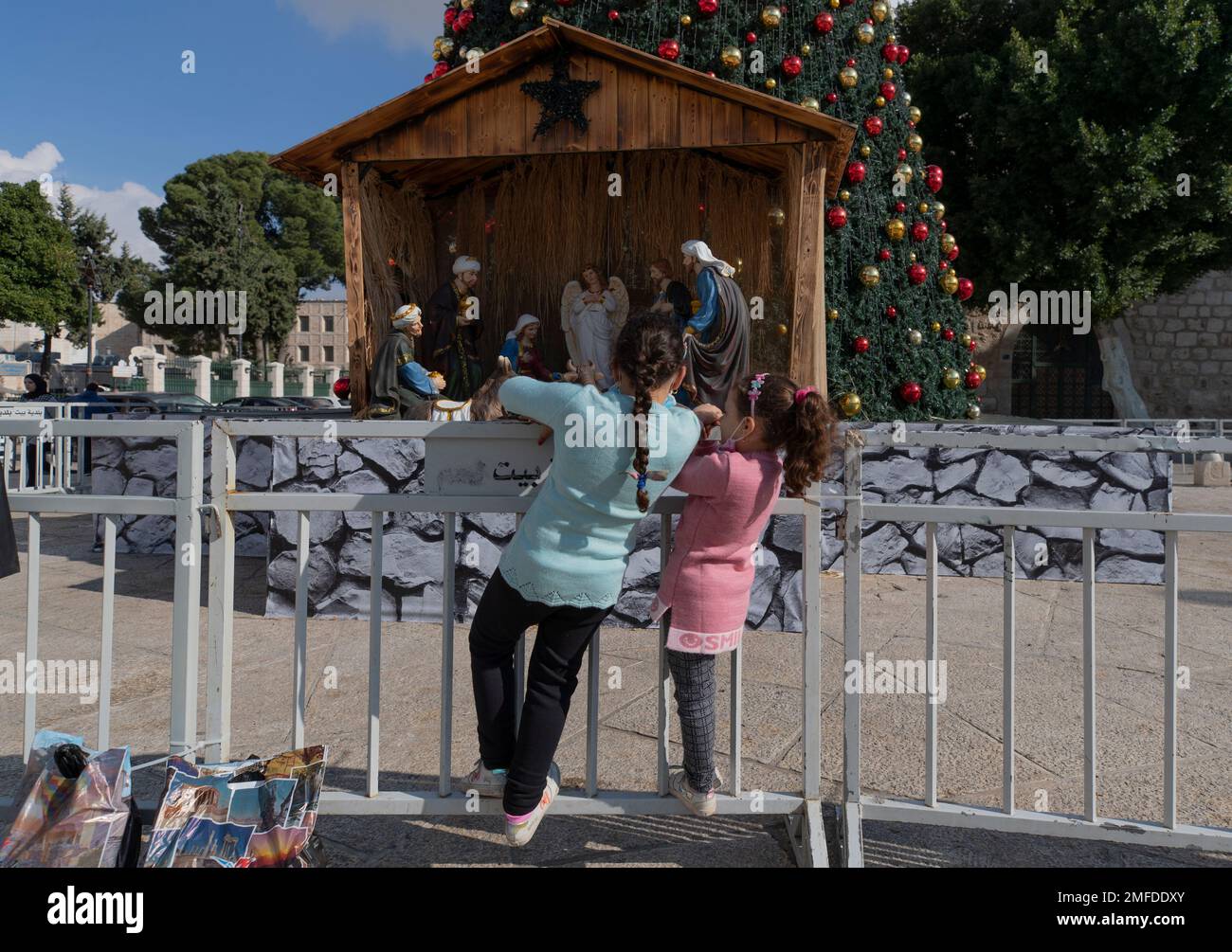 Palestinian children look at the Nativity scene in Manger Square ...