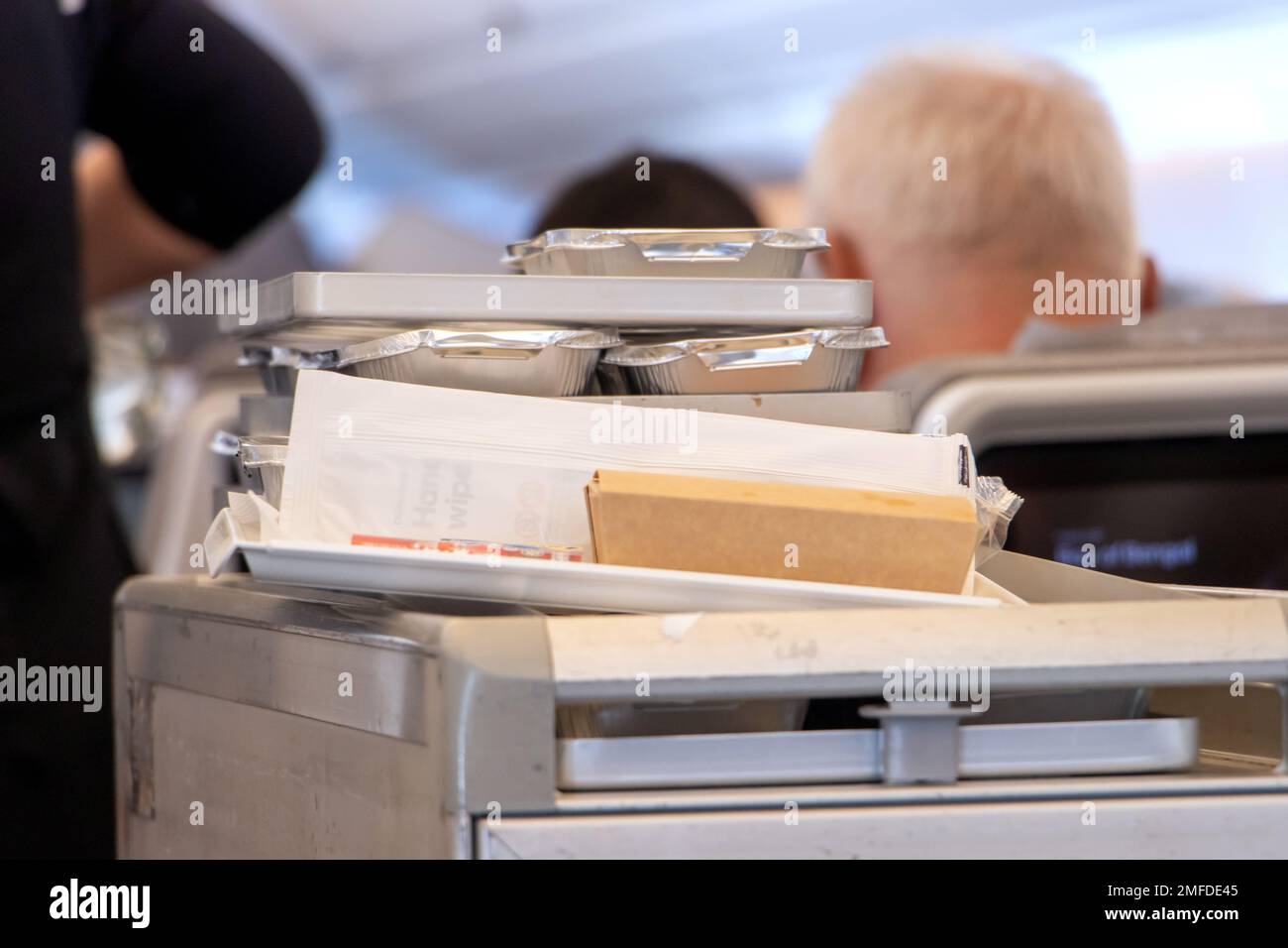 Food delivery in the economy class of the plane Stock Photo - Alamy