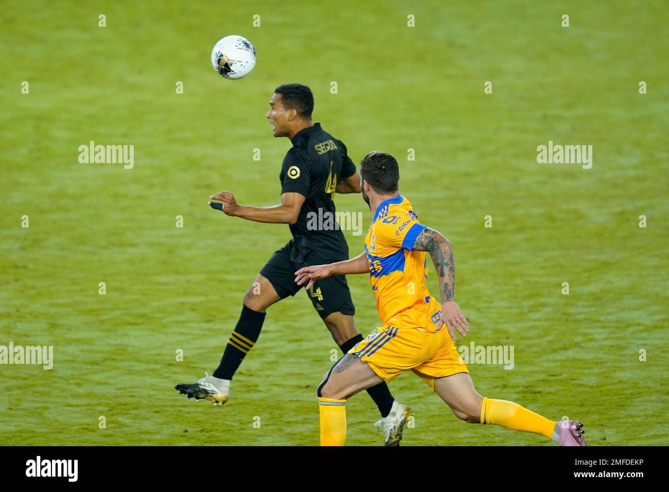 Los Angeles FC defender Eddie Segura, left, heads the ball away from ...