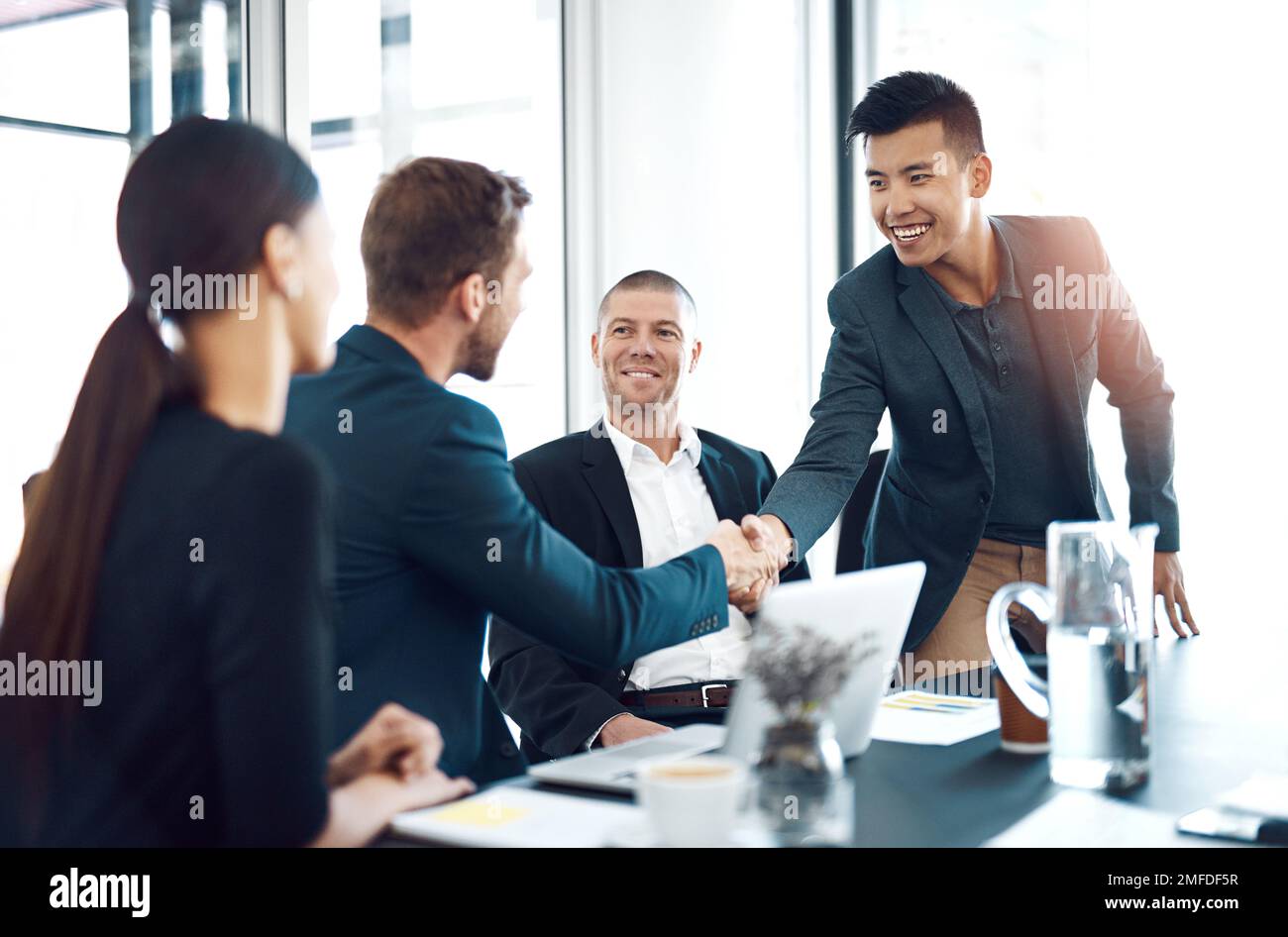 Congratulations on making partner. businesspeople having a meeting in a ...