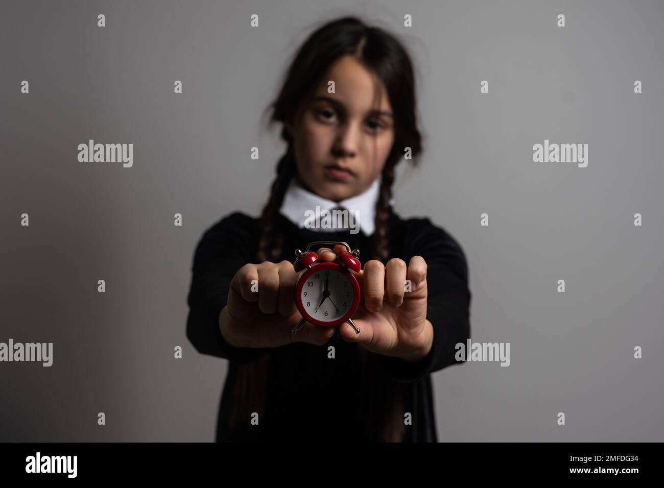 Wednesday Angry girl student clock Stock Photo - Alamy