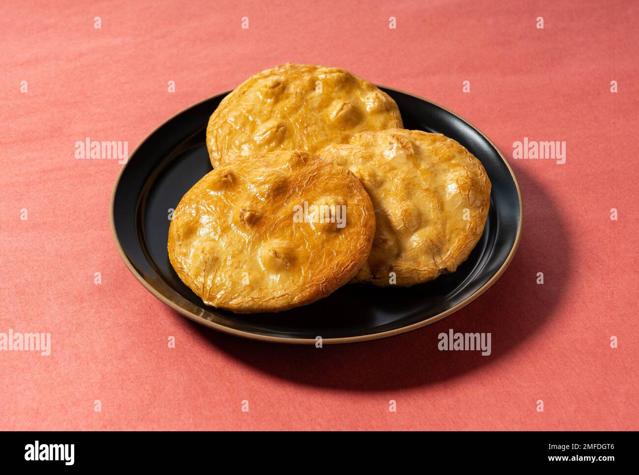 Sembei placed on pink Japanese paper. Sembei is a Japanese snack. A ...