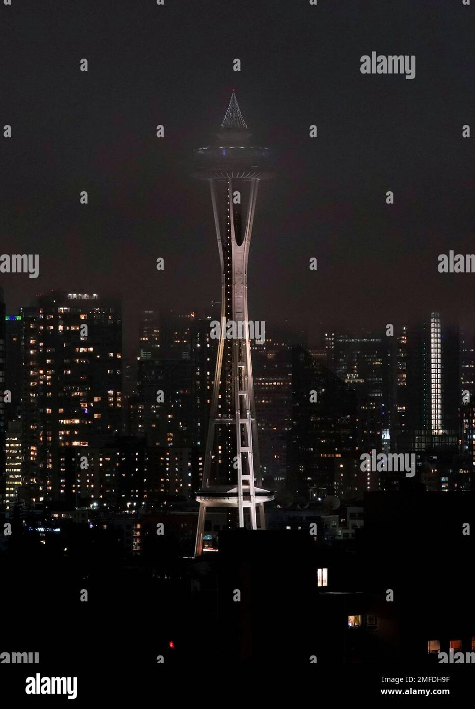 As clouds obscure taller buildings in the background, the Space Needle ...