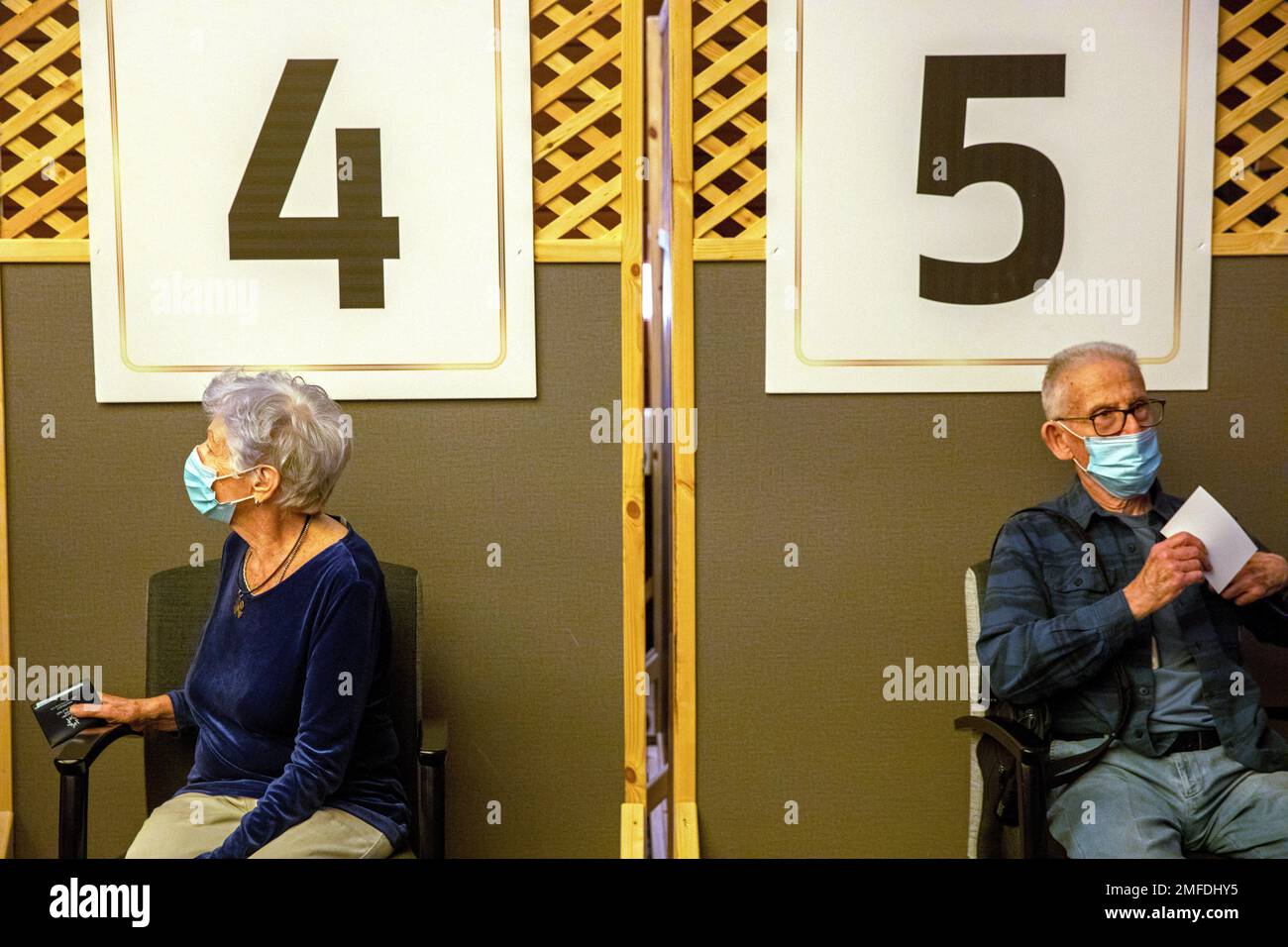 People wait to receive a Pfizer COVID-19 vaccine at a private nursing ...