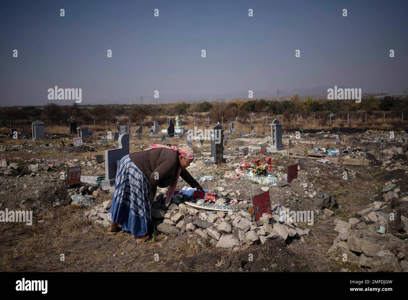 Rebecca Mohapi, who's son Onthatile died last year, puts one of his ...