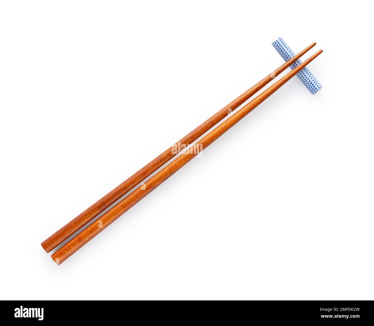 Wooden chopsticks and chopstick rests placed on a white background ...