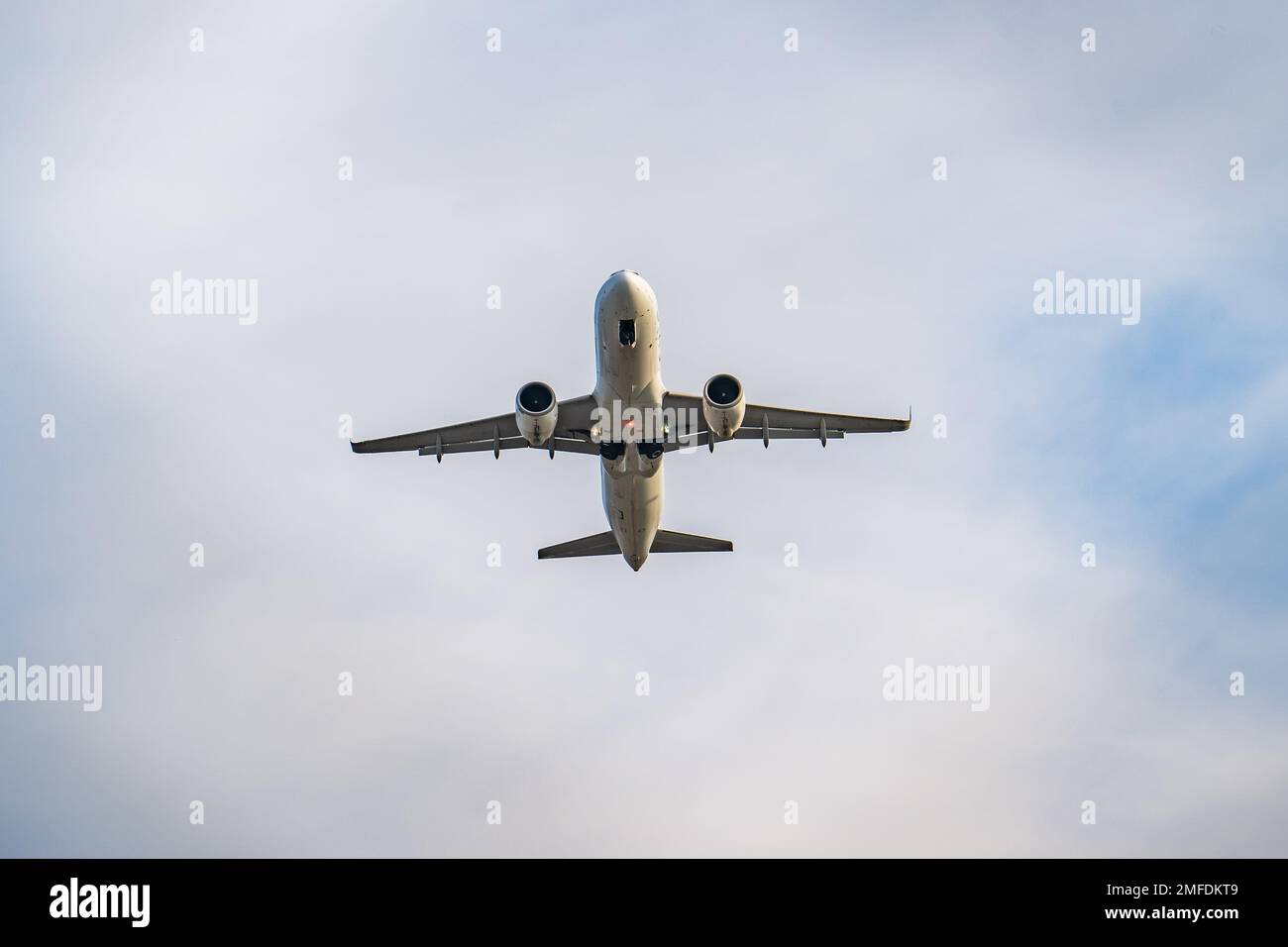 Passenger plane flies in sky, view from below. Airplane travel concept ...
