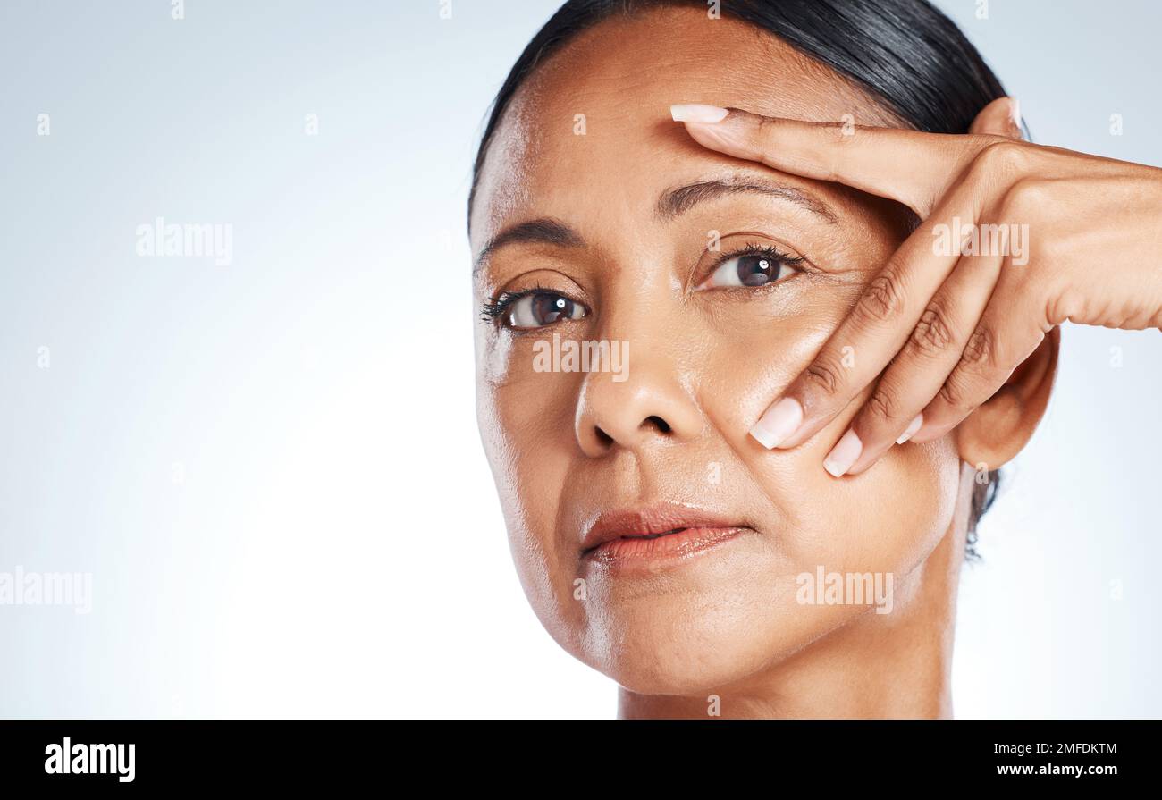 Face portrait, beauty and senior woman in studio isolated on gray ...