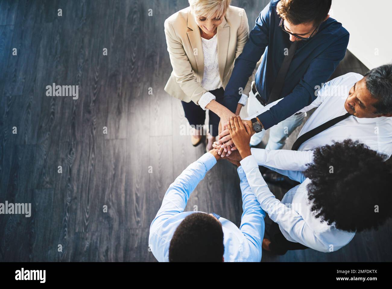 Lets get in it to win it. a group of businesspeople joining their hands ...