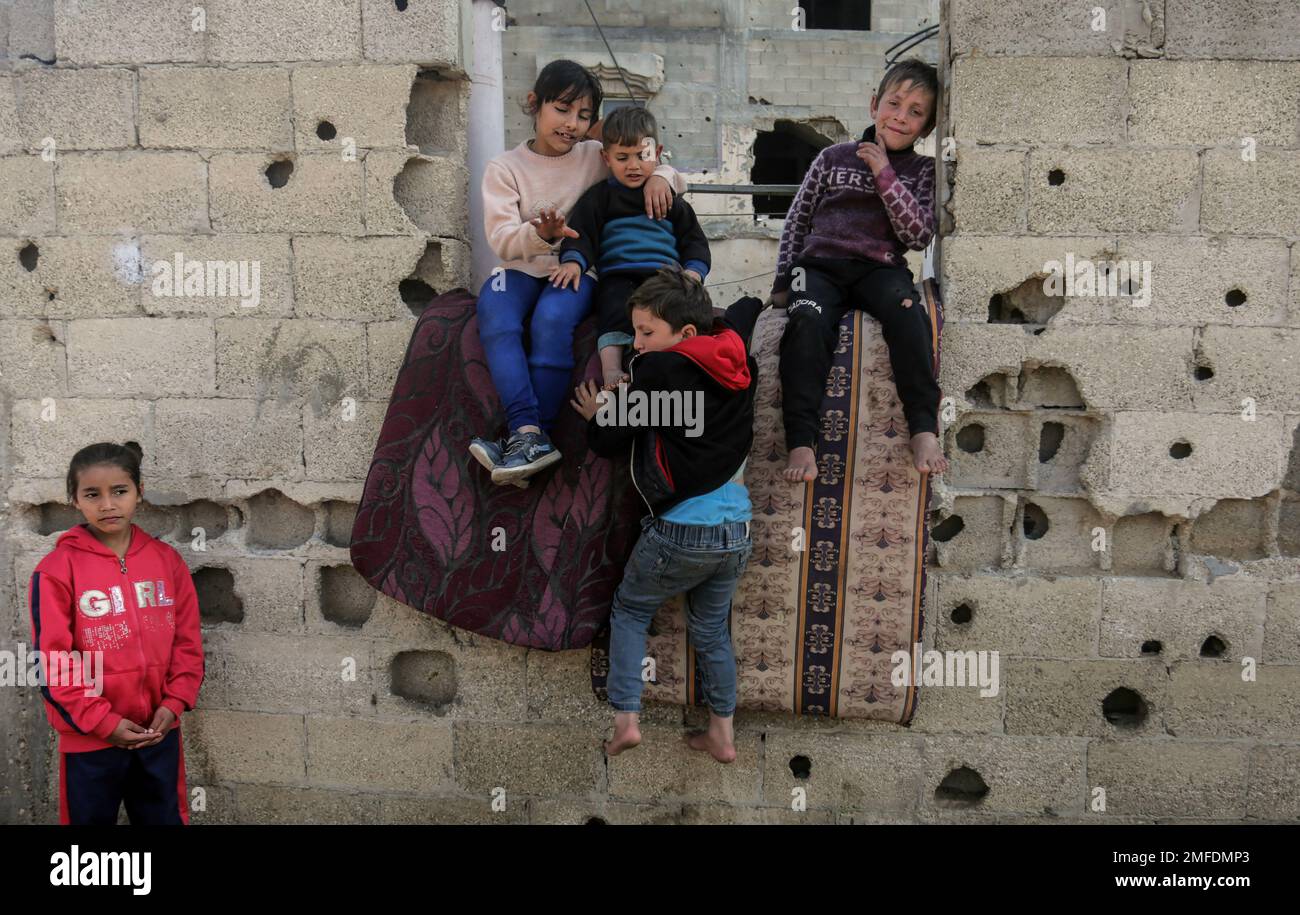Palestinian children play in front of their house in a poor ...