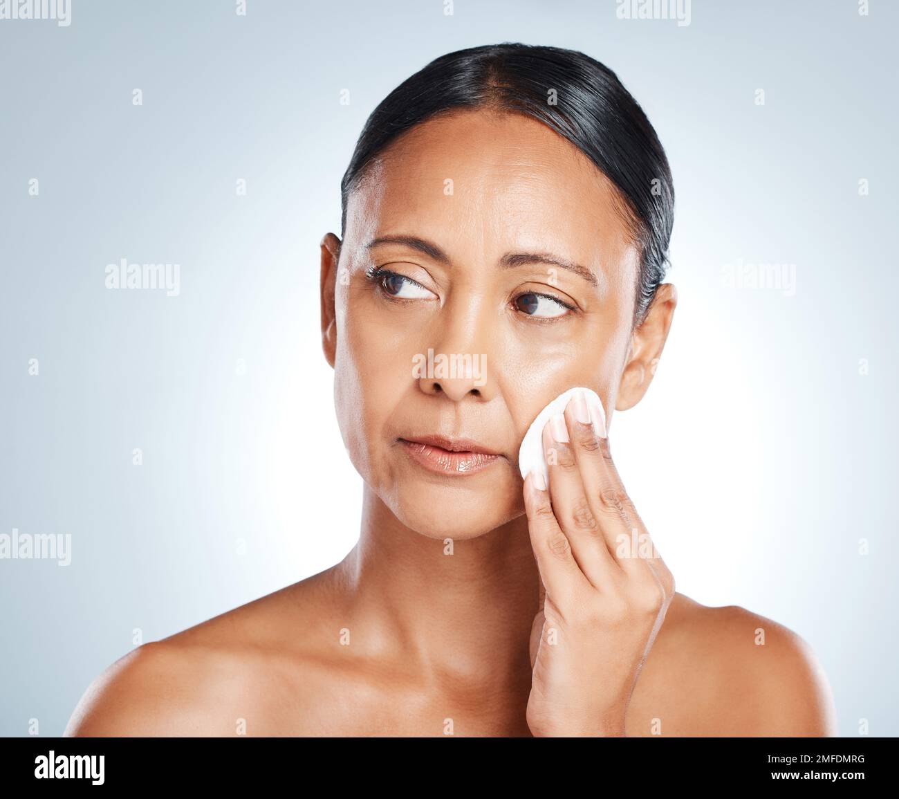 Face, beauty and senior woman with cotton in studio isolated on gray ...