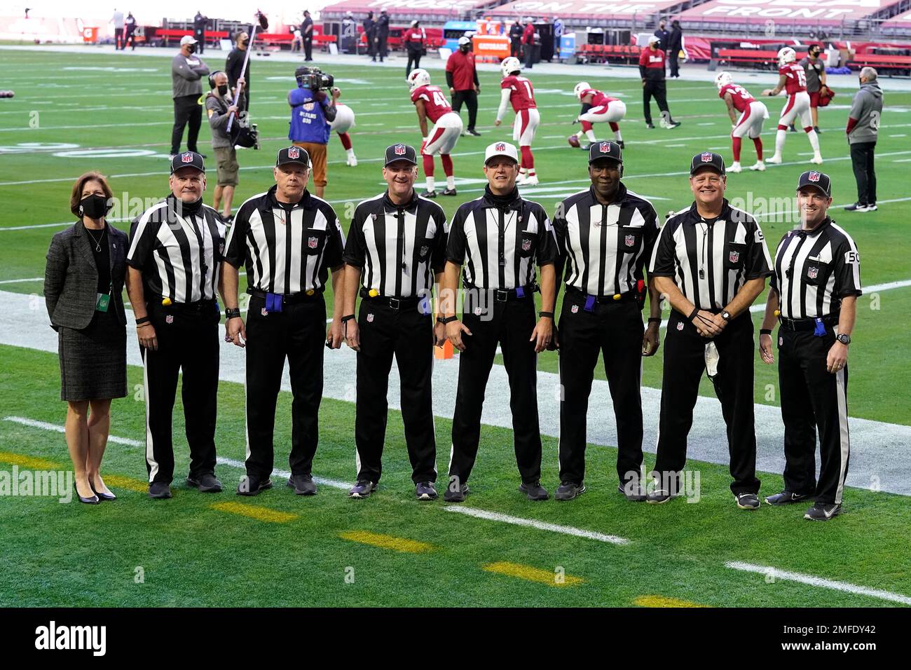 From right; field judge Aaron Santi, head linesman Jerry Bergman ...