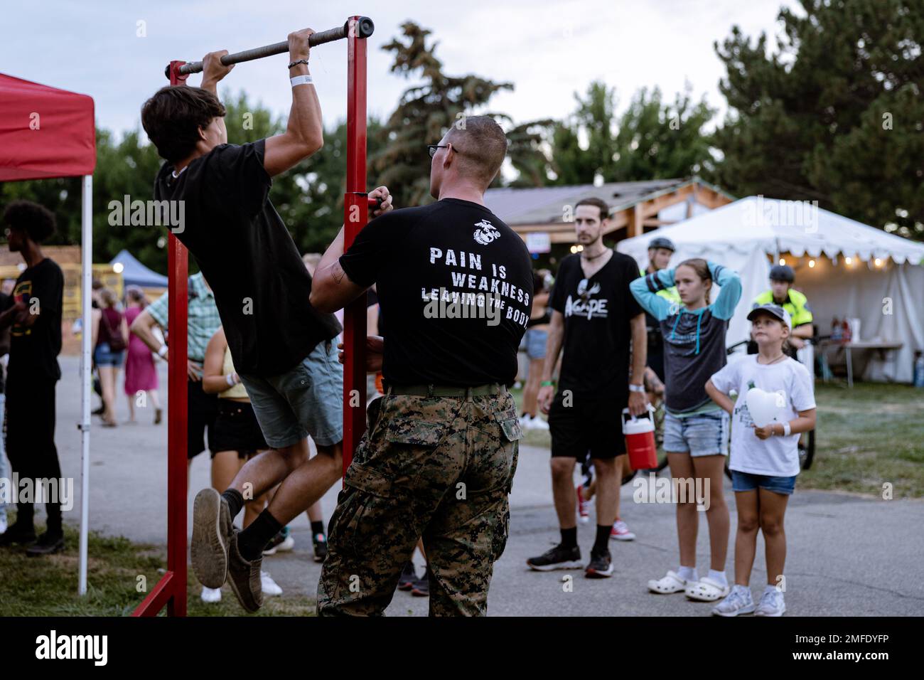 U.S. Marines encourage people during a pull-up contest at the Western ...