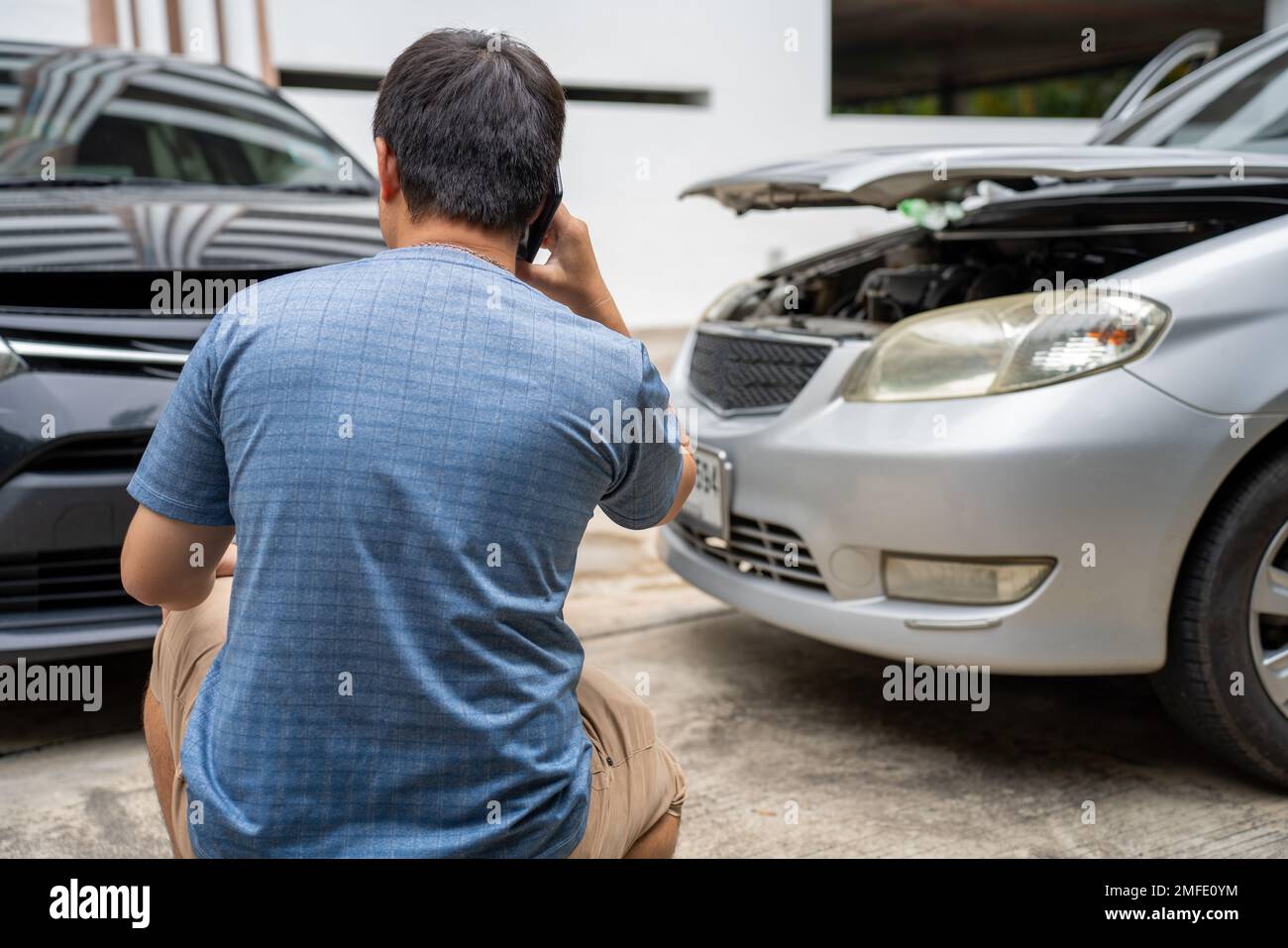 One man reporting car crash damage calling insurance and Claim roadside ...