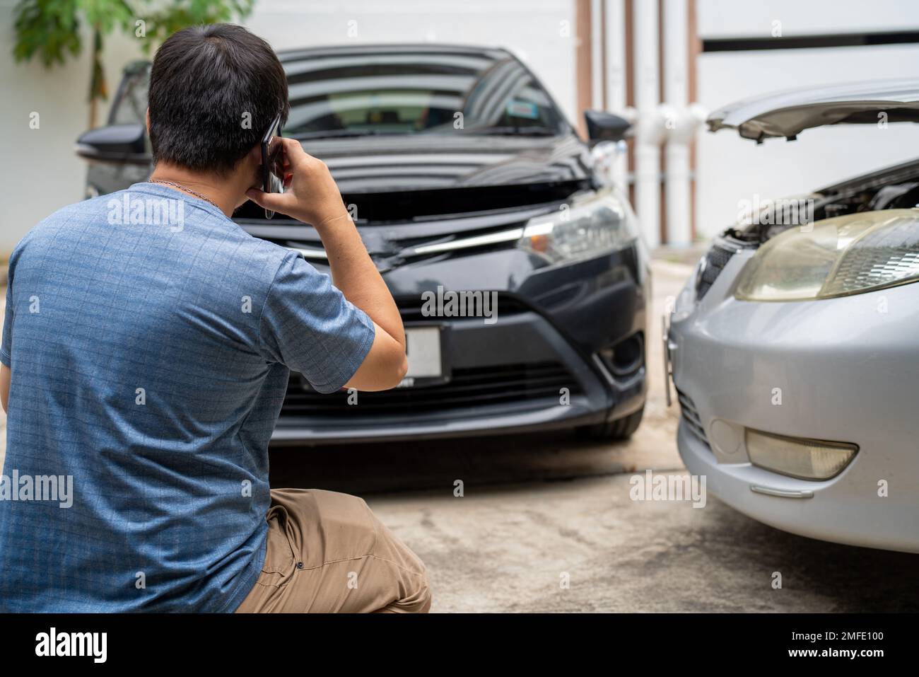 One man reporting car crash damage calling insurance and Claim roadside ...