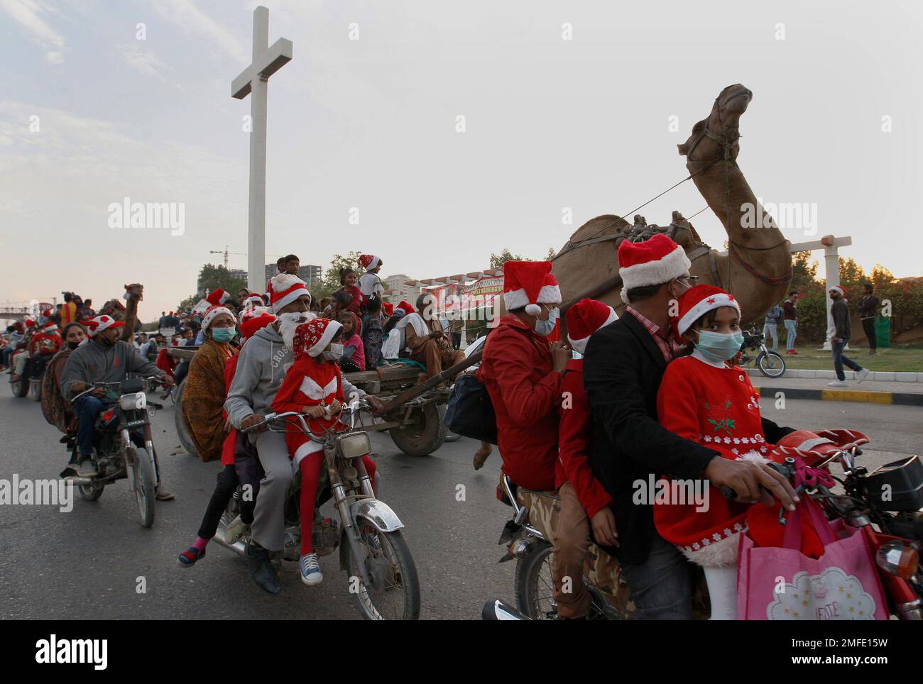 Christians, some wearing Santa Claus suits, participate in a Christmas ...