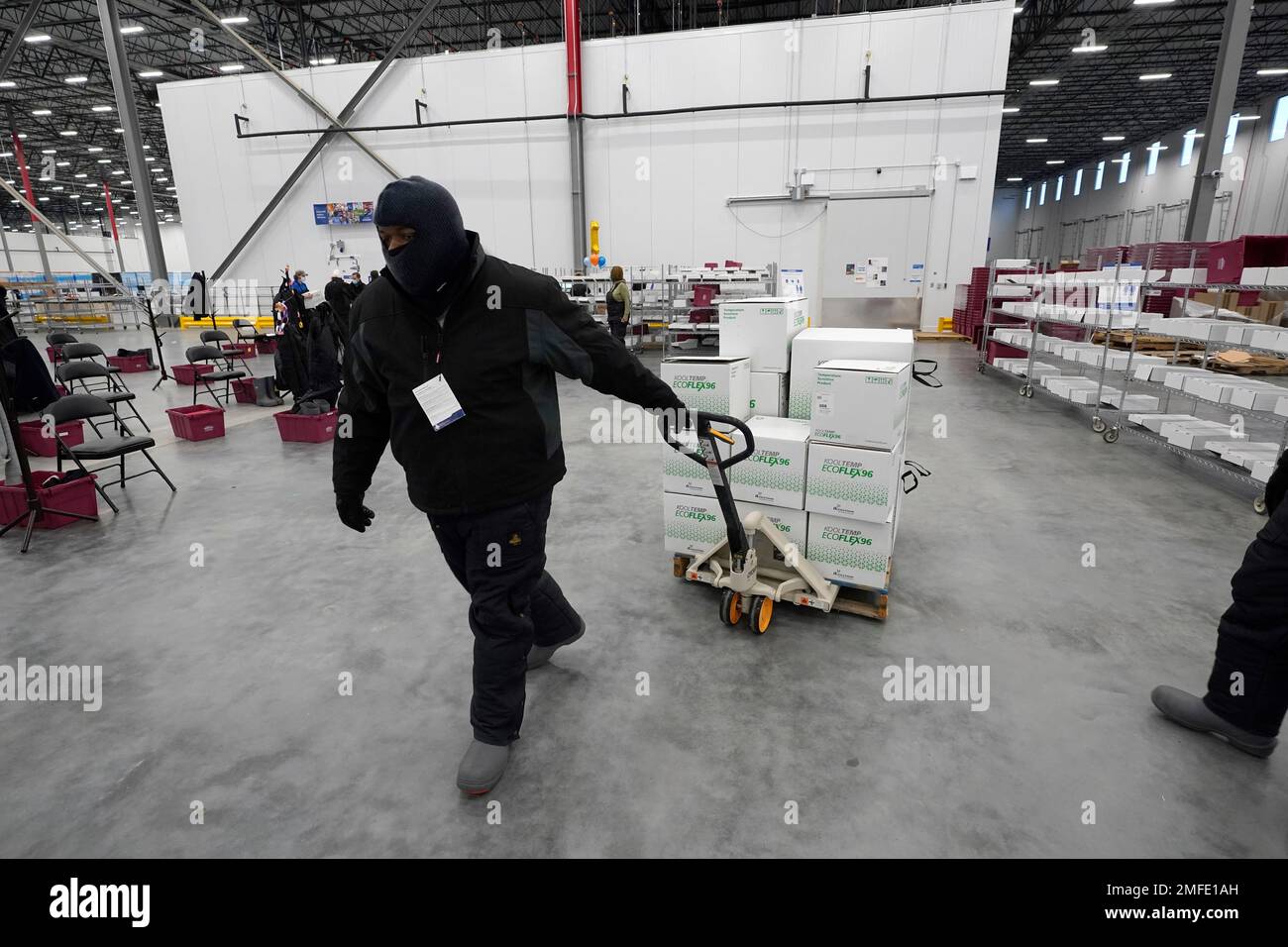 Boxes containing the Moderna COVID-19 vaccine are moved to the loading ...