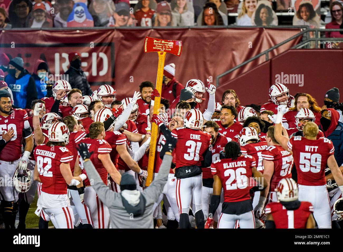 Wisconsin celebrates with the Paul Bunyan Axe Trophy after beating ...