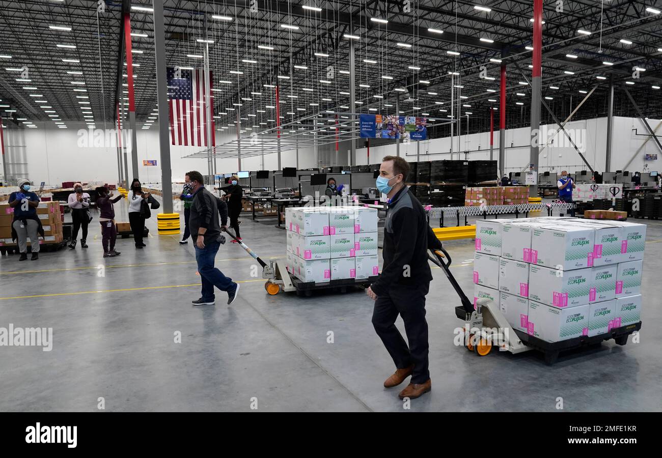 Boxes containing the Moderna COVID-19 vaccine are moved to the loading ...