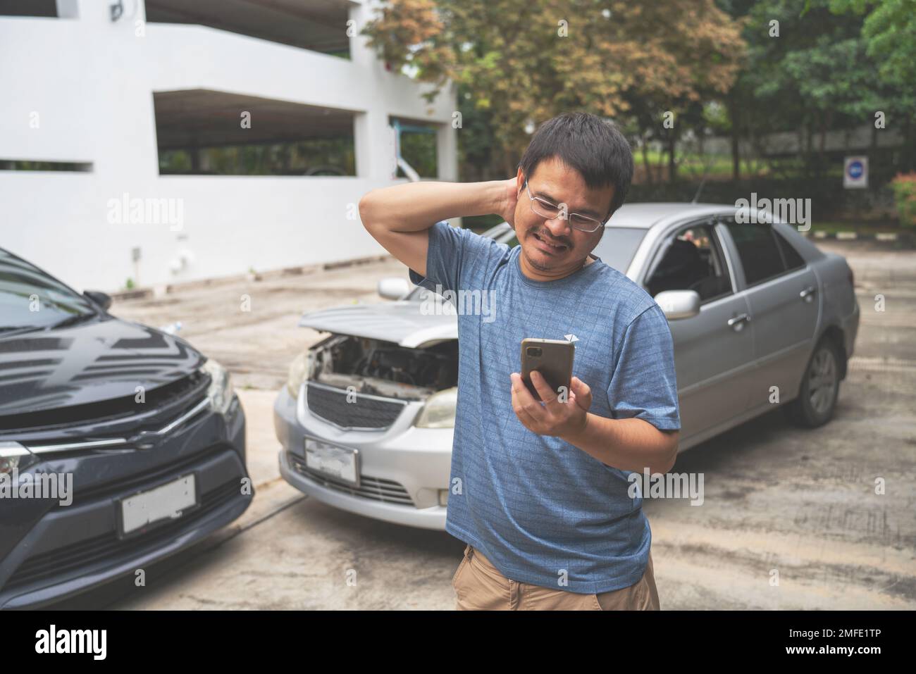 One man reporting car crash damage calling insurance and Claim roadside ...