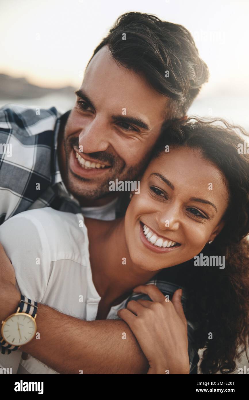 Love is the most amazing feeling. a young man hugging his girlfriend ...