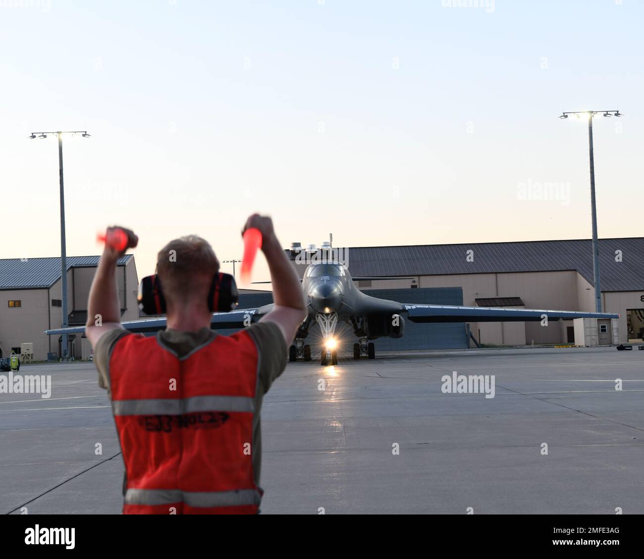 U.S. Air Force airmen directs a B-1B Lancer onto the runway during a ...